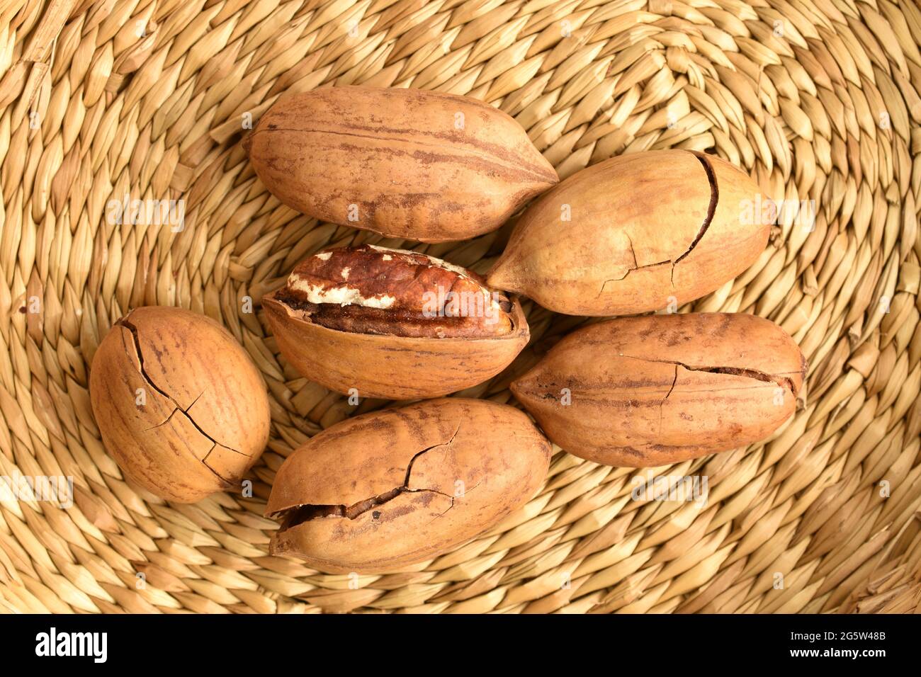 Several organic ripe pecans, on a straw mat, close-up, top view Stock ...