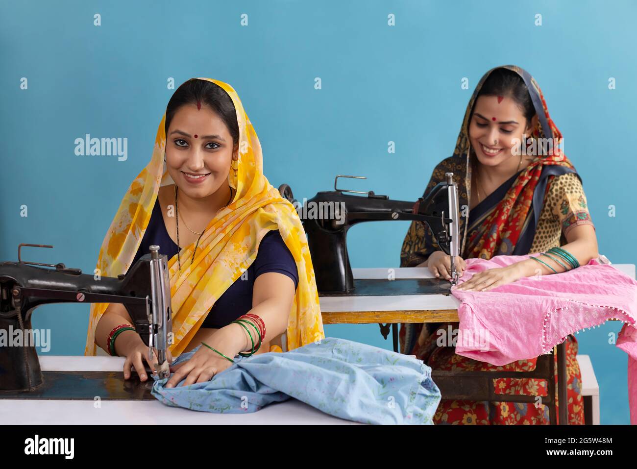 Two rural women working on sewing machines Stock Photo - Alamy