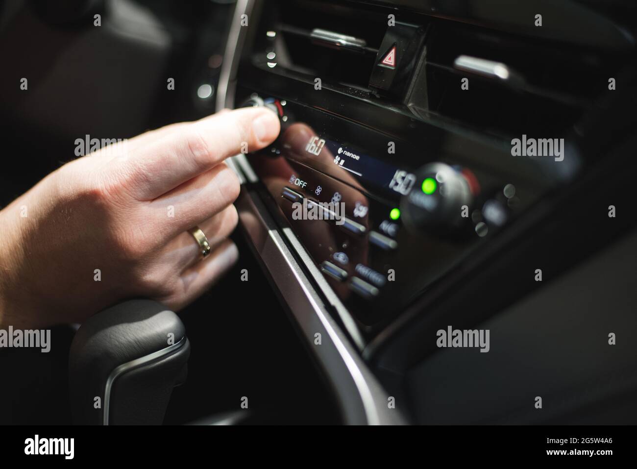 Male driver controls the settings of his car with buttons Stock Photo ...