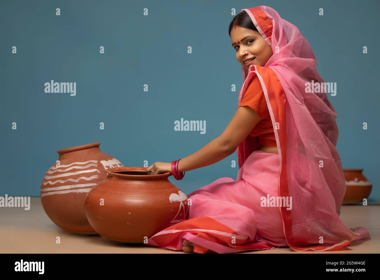 A woman sitting with matkis Stock Photo - Alamy