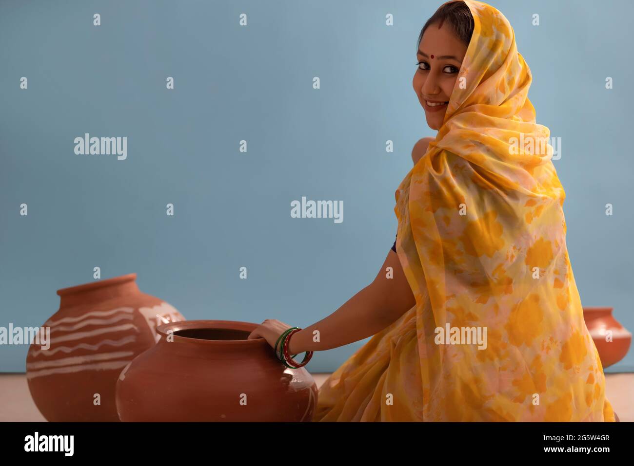 A woman sitting with matkis Stock Photo - Alamy