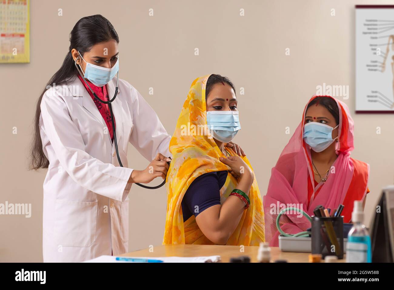 A lady doctor examining a rural woman Stock Photo - Alamy
