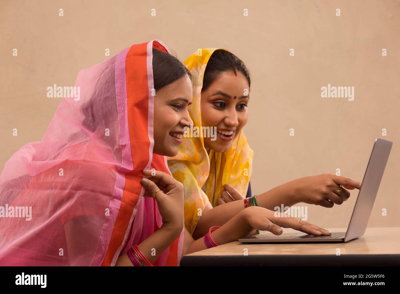 Two rural women engaged in online shopping Stock Photo - Alamy