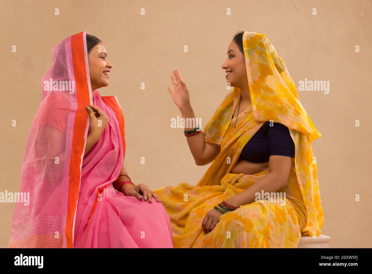 Two rural women talking to each other Stock Photo - Alamy