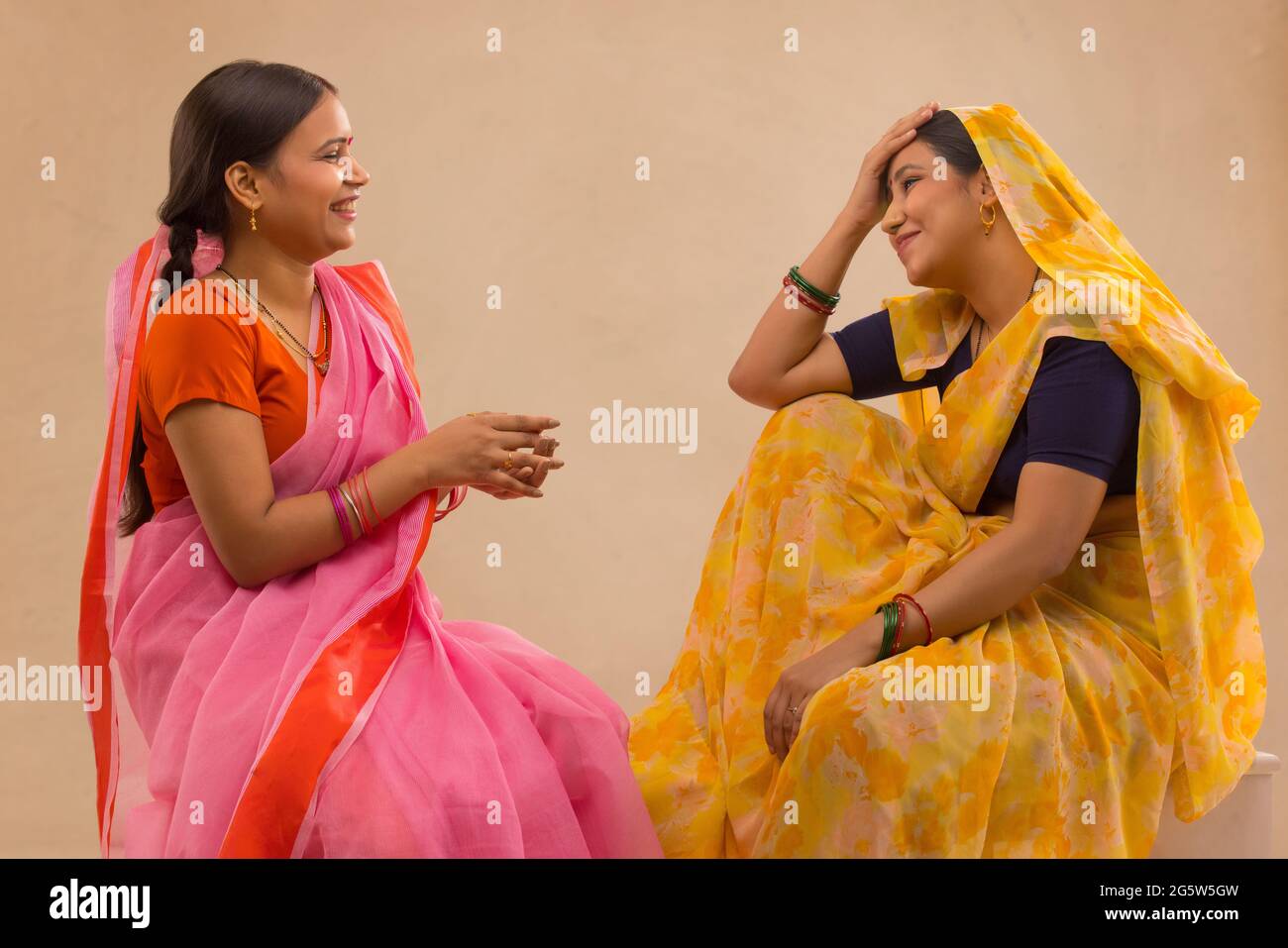 Two rural women talking to each other Stock Photo - Alamy