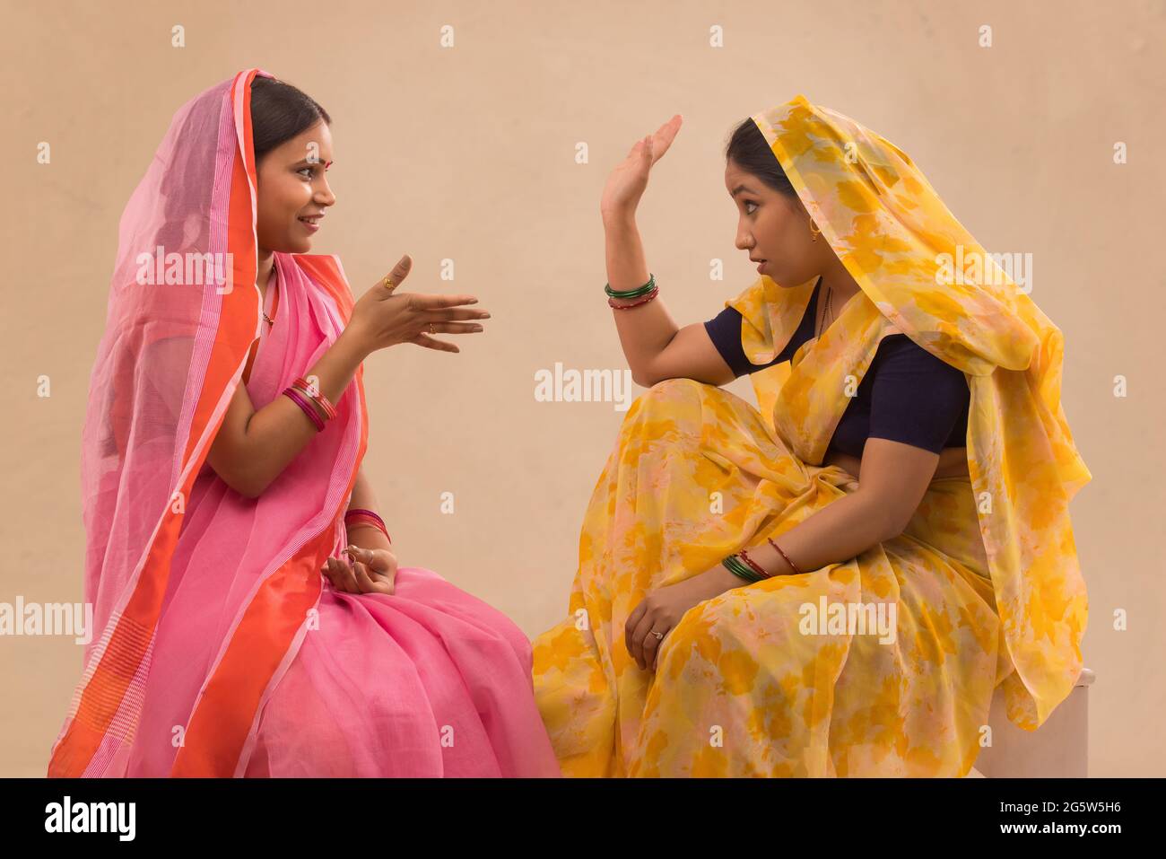 Two rural women talking to each other Stock Photo - Alamy