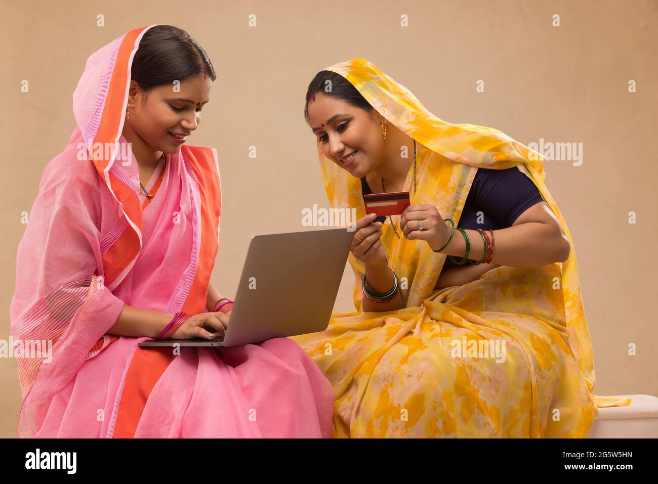 Two rural women engaged in online shopping Stock Photo - Alamy