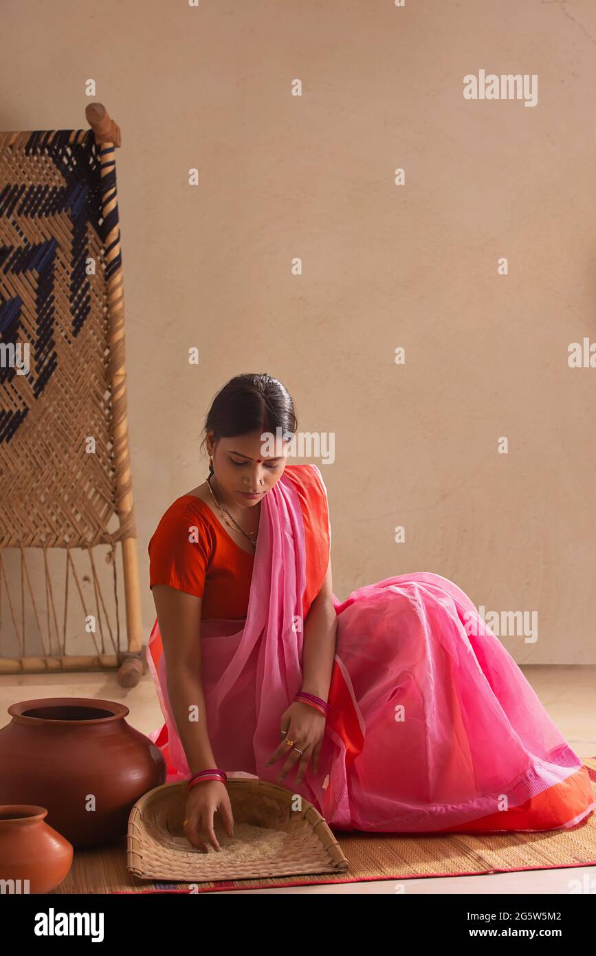 A rural woman hand picking grains in a sieve Stock Photo - Alamy