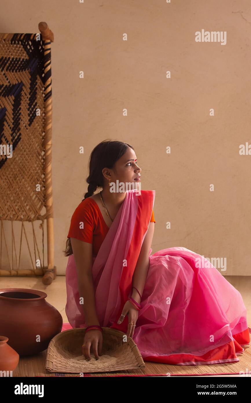 A rural woman hand picking grains in a sieve Stock Photo - Alamy