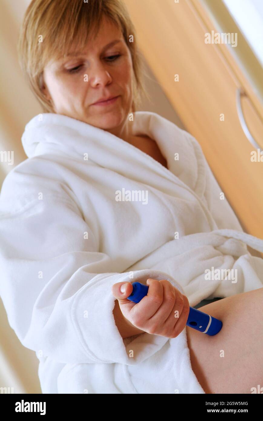 early thirties female self injecting a drug or insulin or Epinephrine ...