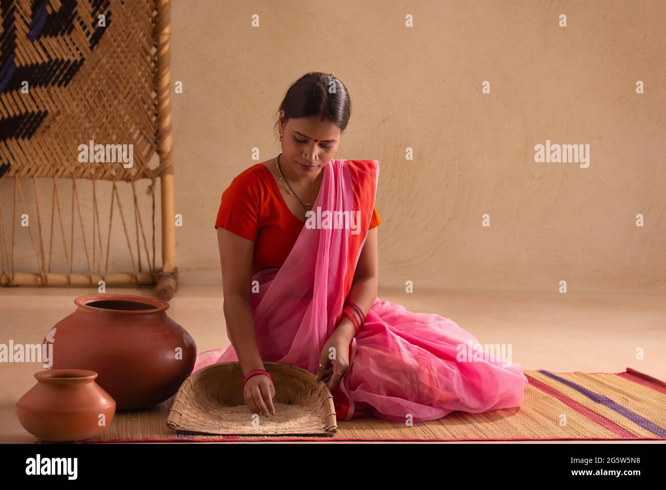 A rural woman hand picking grains in a sieve Stock Photo - Alamy