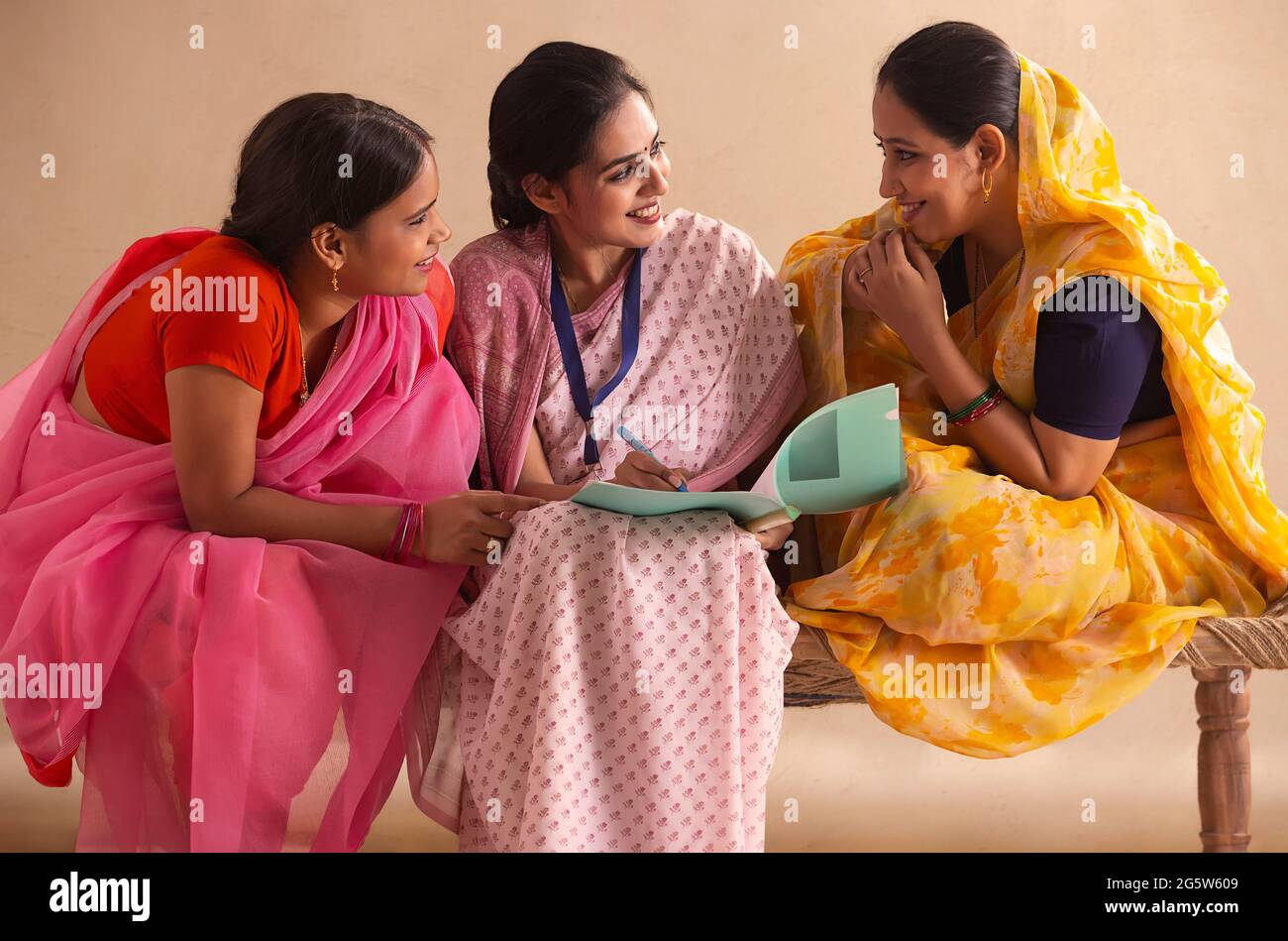 A lady officer talking to two rural women Stock Photo - Alamy