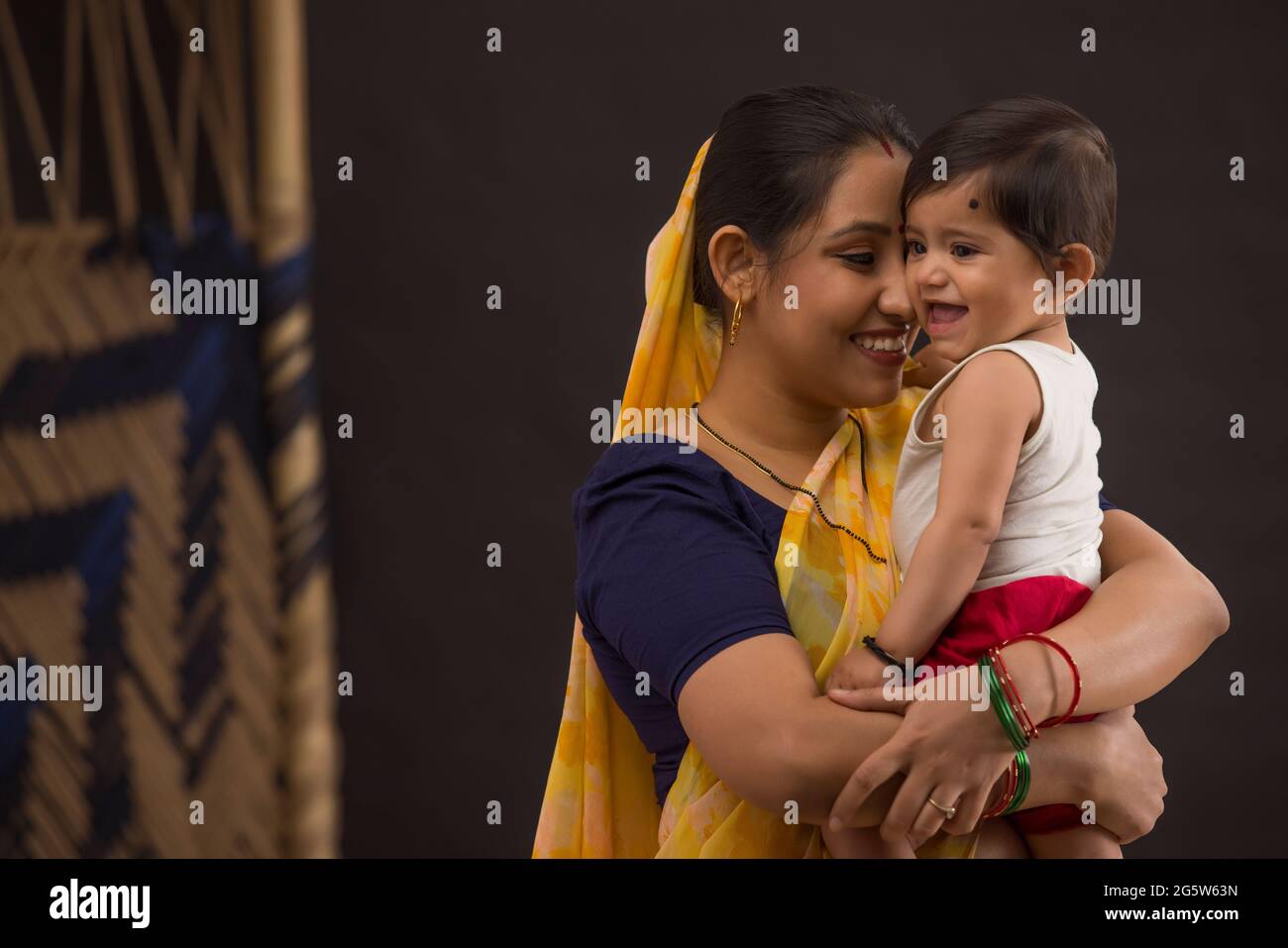 A woman holding her baby with affection Stock Photo - Alamy