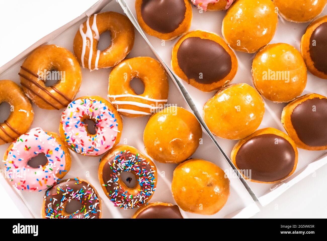Flat lay. Variety of store-bought doughnuts in a white paper box Stock ...