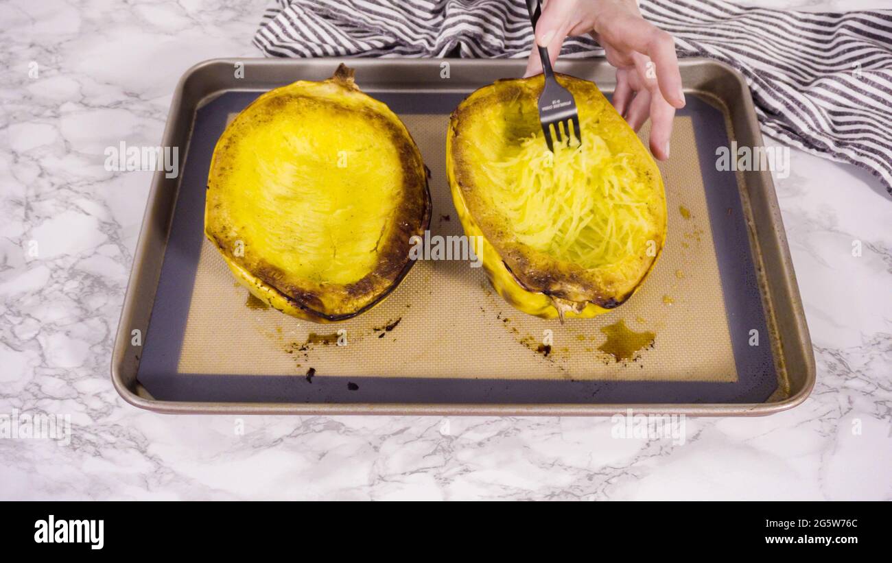 Step by step. Preparing organic spaghetti squash with olive oil, salt ...