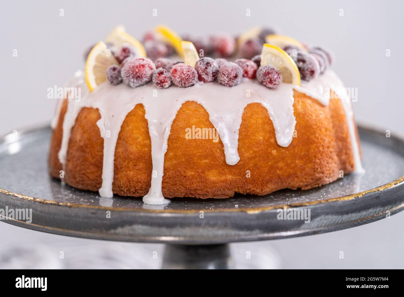 Lemon cranberry bundt cake decorated with sugar cranberries and lemon ...