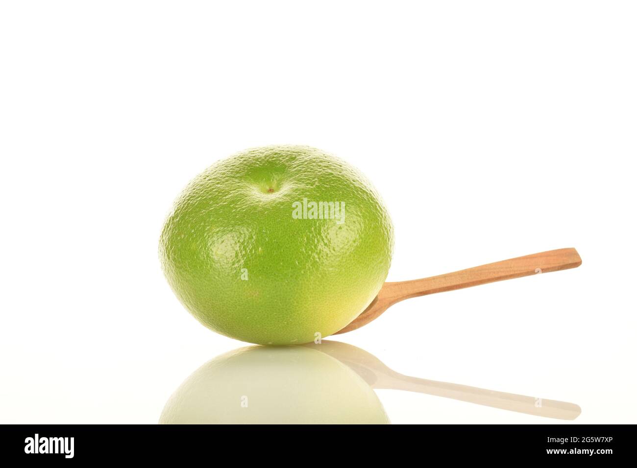 One organic ripe Citrus Sweetie with a wooden spoon, close-up, isolated ...