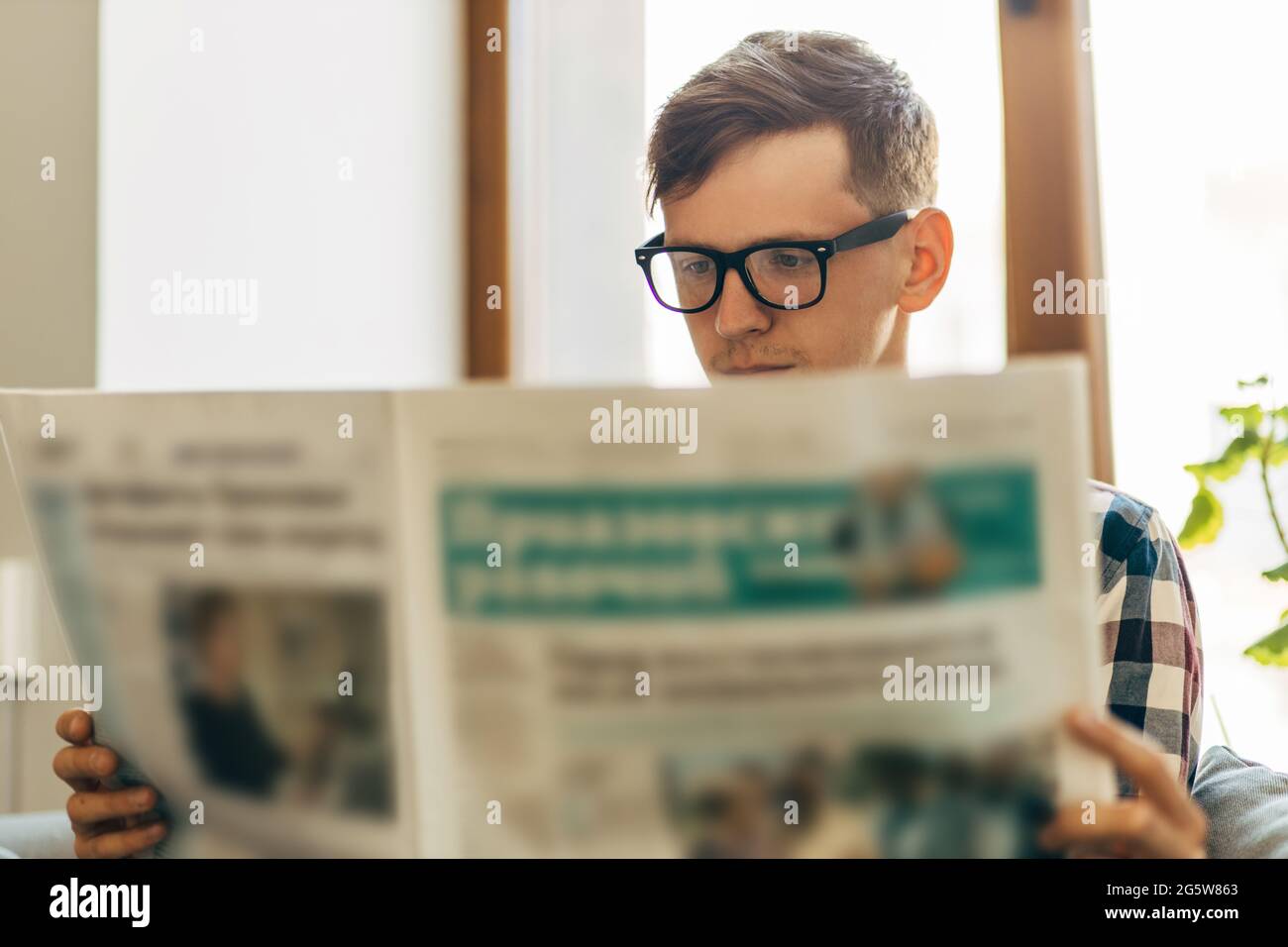 Person holding reading open newspaper hi-res stock photography and ...