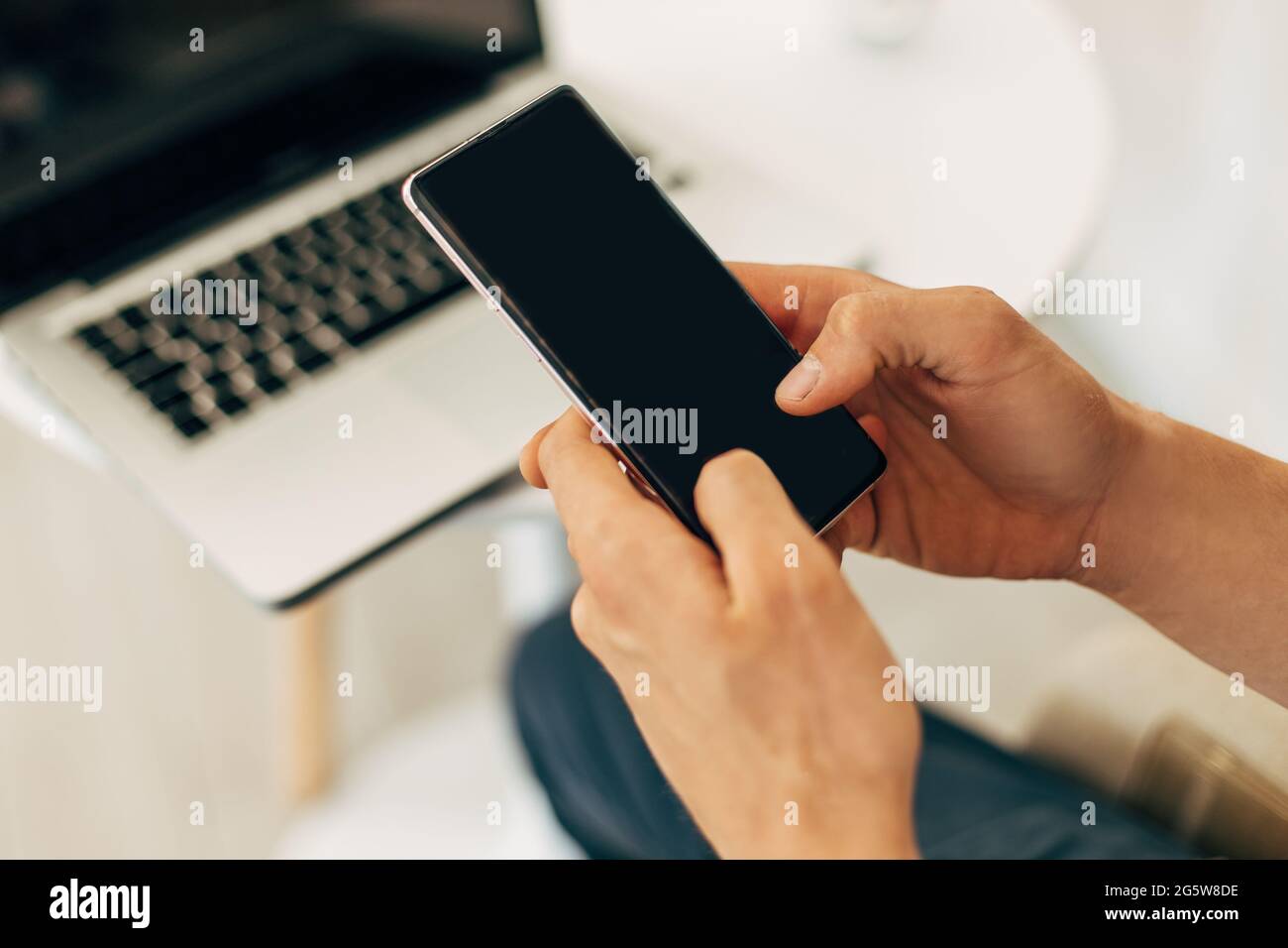 Close up man working with modern devices, man using laptop and mobile ...