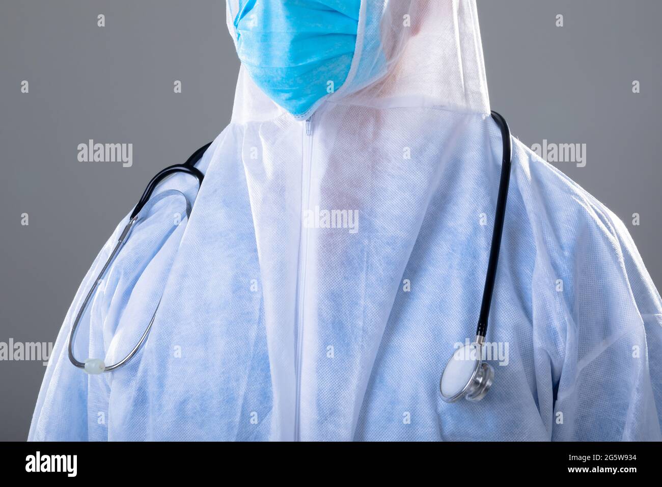 Caucasian male doctor wearing ppe suit, isolated on grey background ...