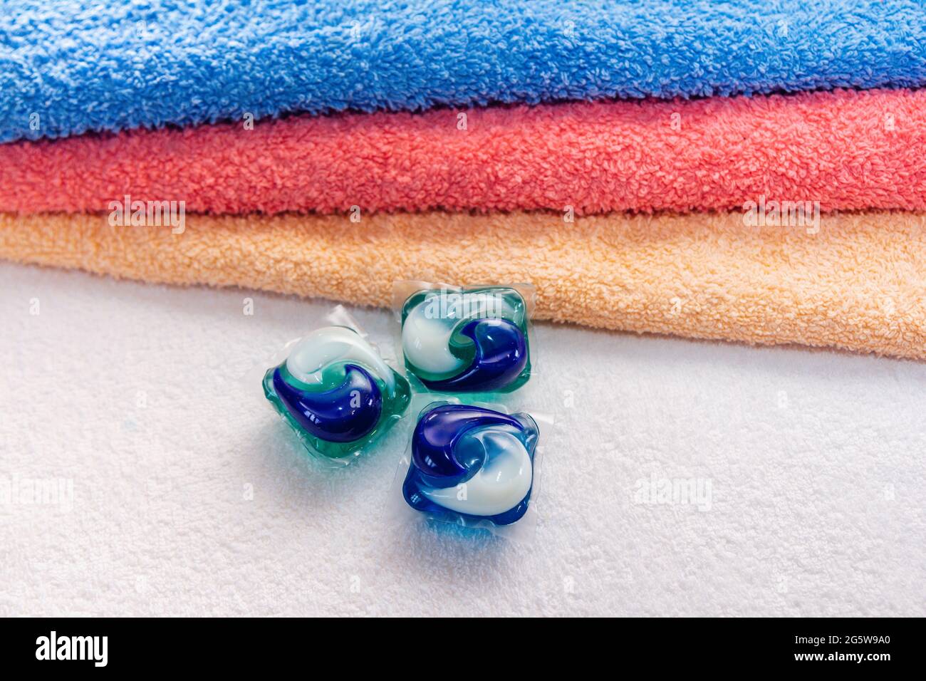 Laundry detergent pods for washing machine and colorful bath towels ...