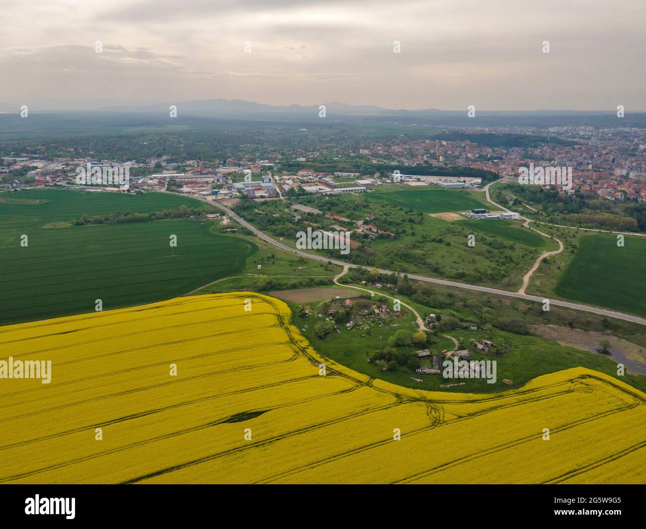 Aerial view of Blooming rapeseed field near city of Haskovo, Bulgaria ...