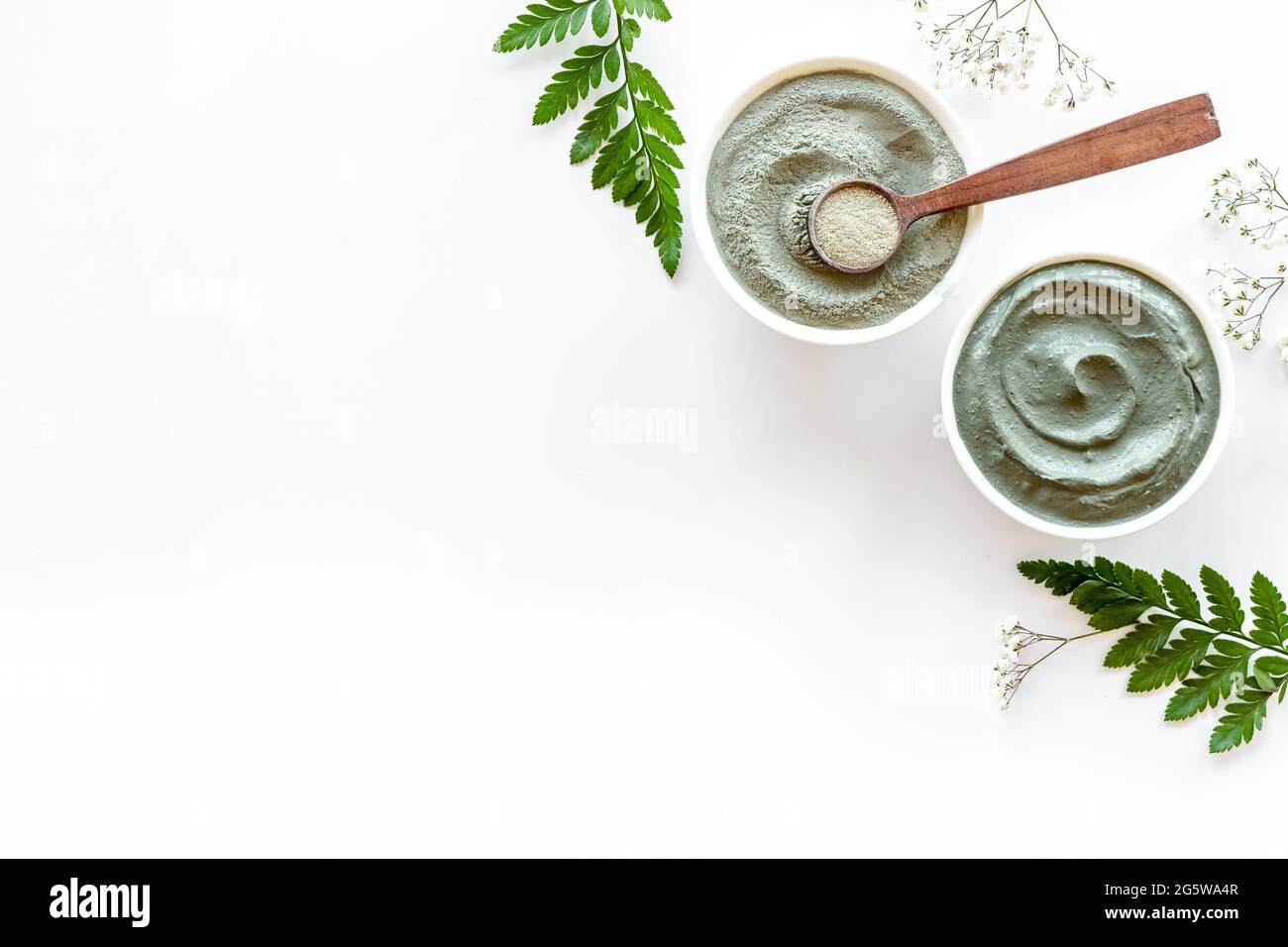Blue clay cosmetic powder and mask in bowls. Top view Stock Photo - Alamy