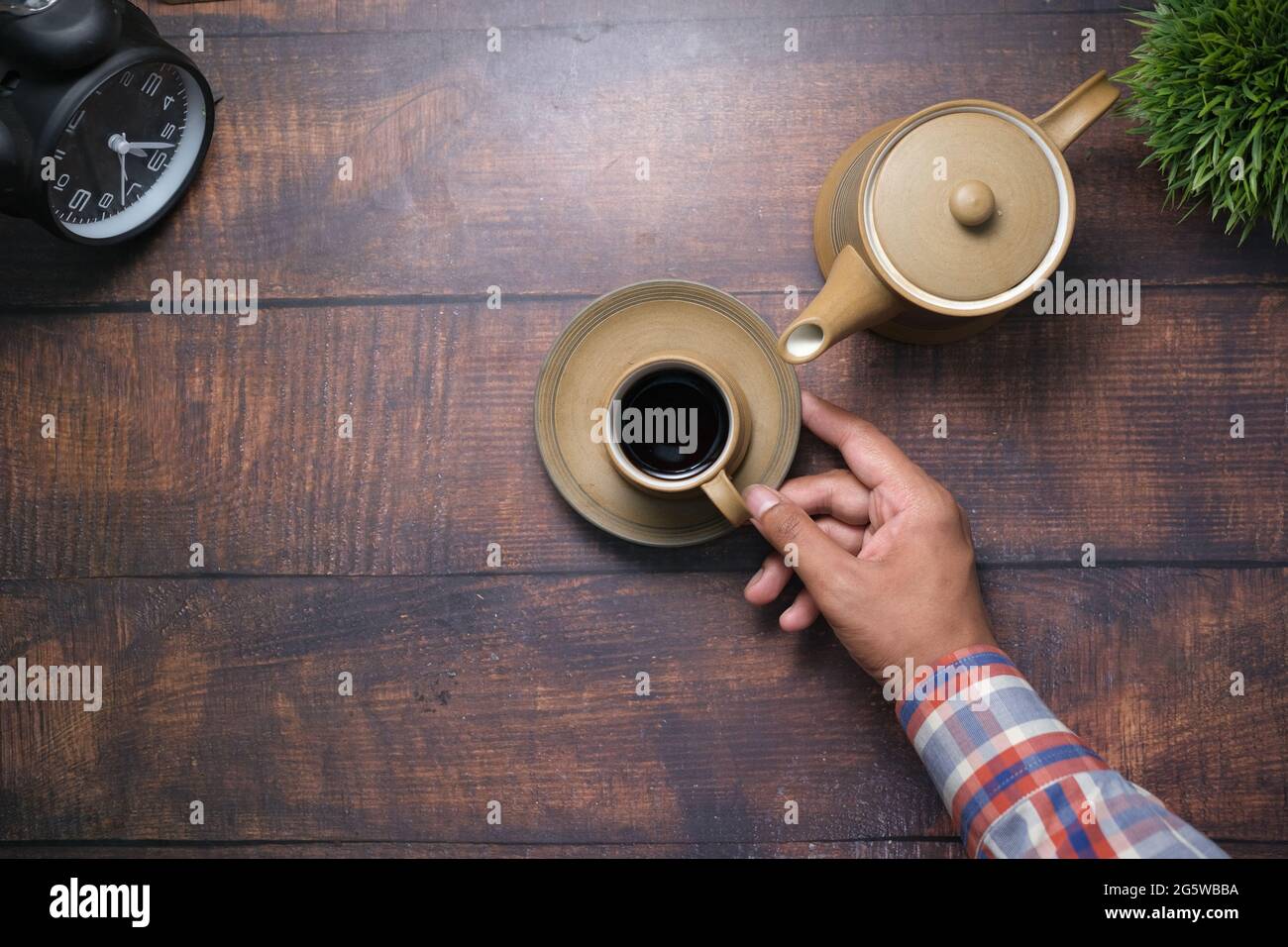 hand holding cup of green tea with copy space Stock Photo - Alamy