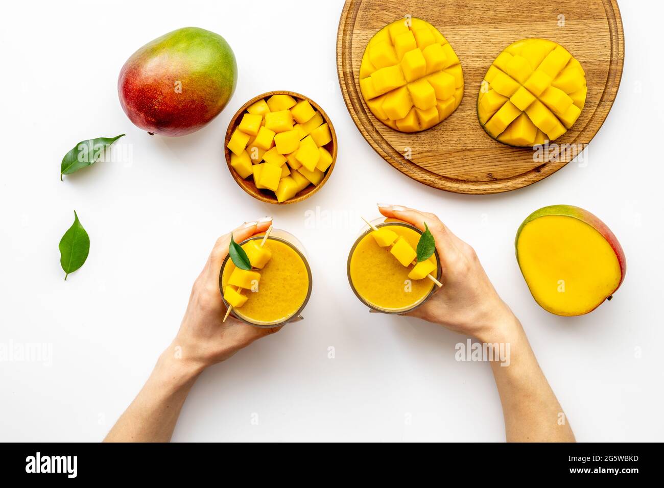 Mango slices and cubes with fresh mango smoothie. Top view Stock Photo - Alamy