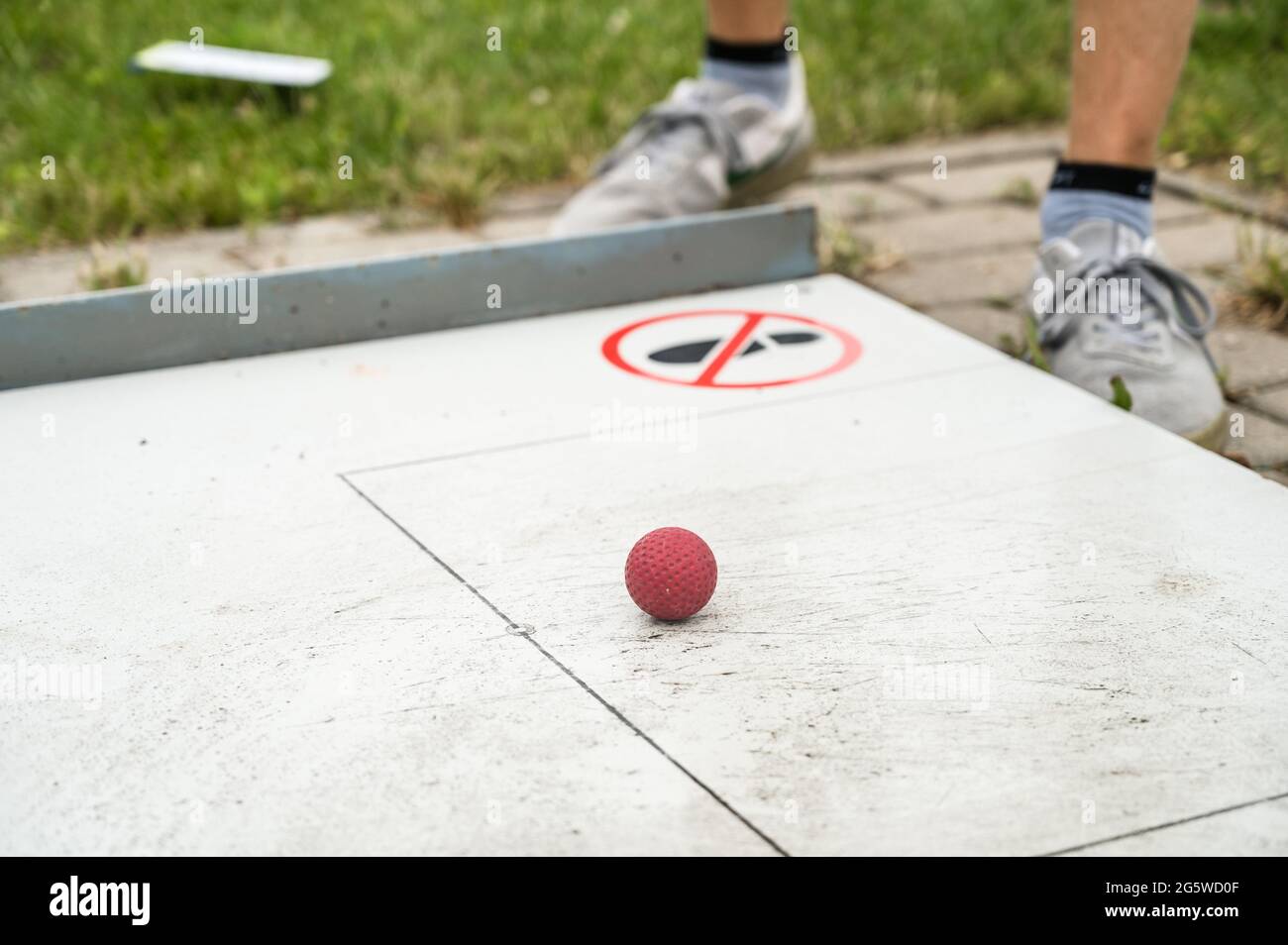 Mini golf course. Close-up of red ball. Start of the game. Summer ...