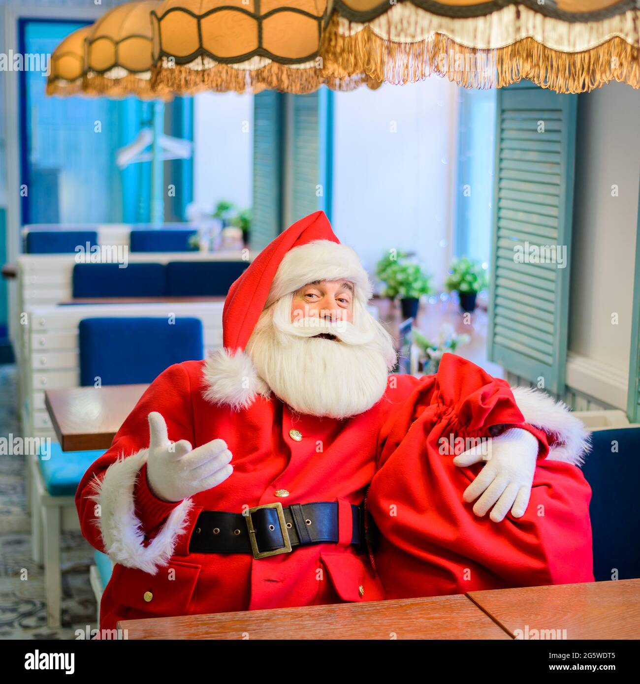 Friendly santa claus in a cafe Stock Photo - Alamy