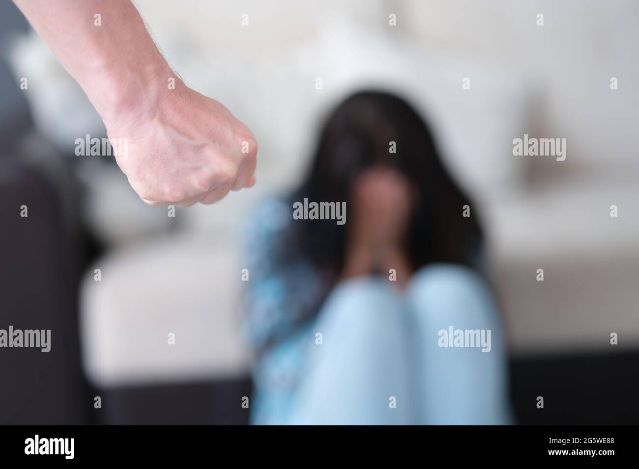 Man stands with fist clenched against background of crying woman Stock ...