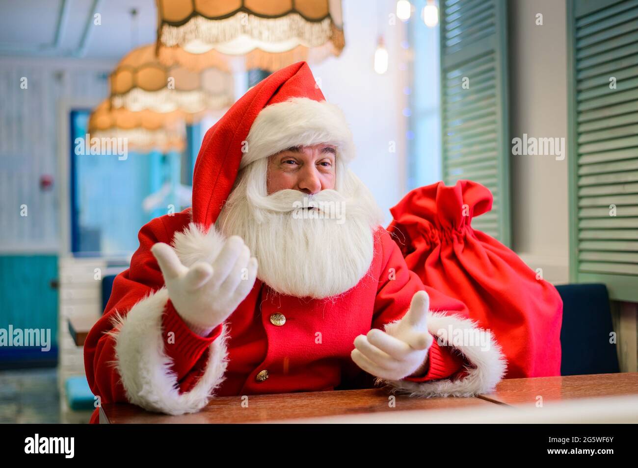 Friendly santa claus in a cafe Stock Photo - Alamy