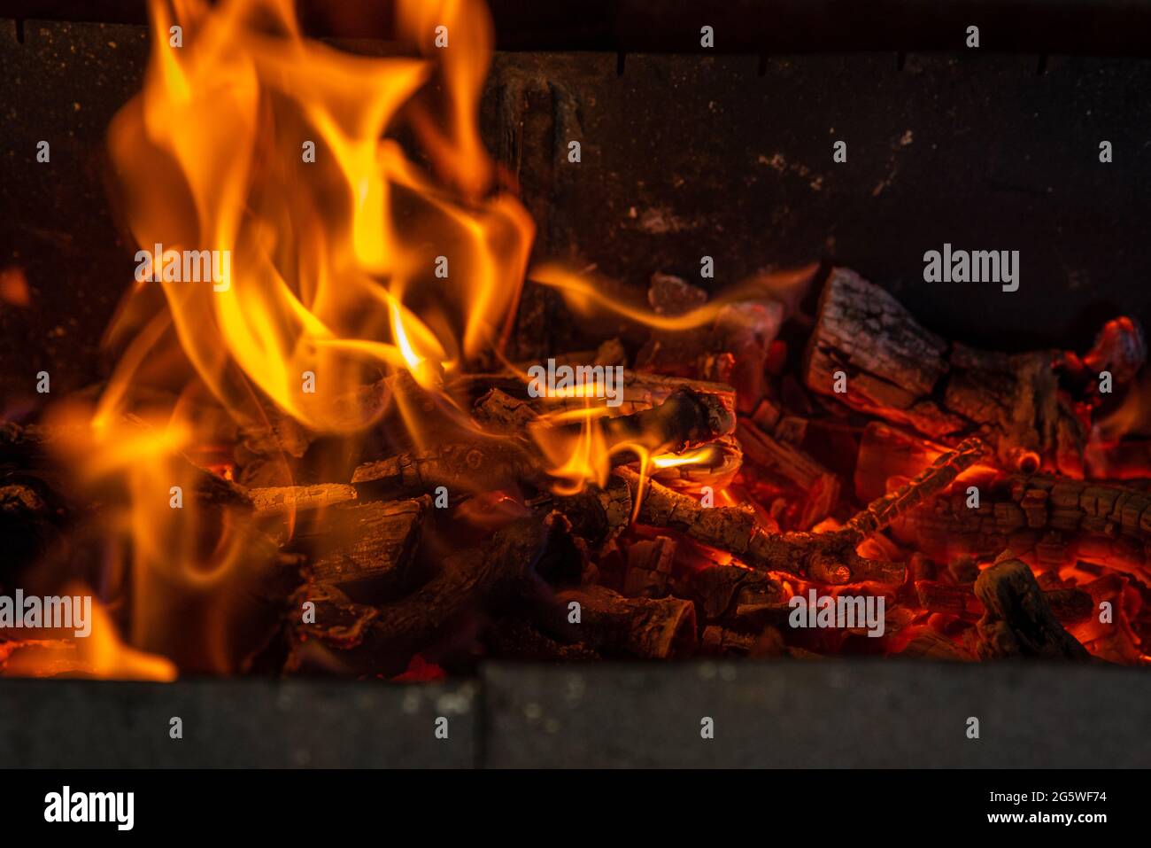 Glowing embers in hot red color. The hot embers of burning wood log ...