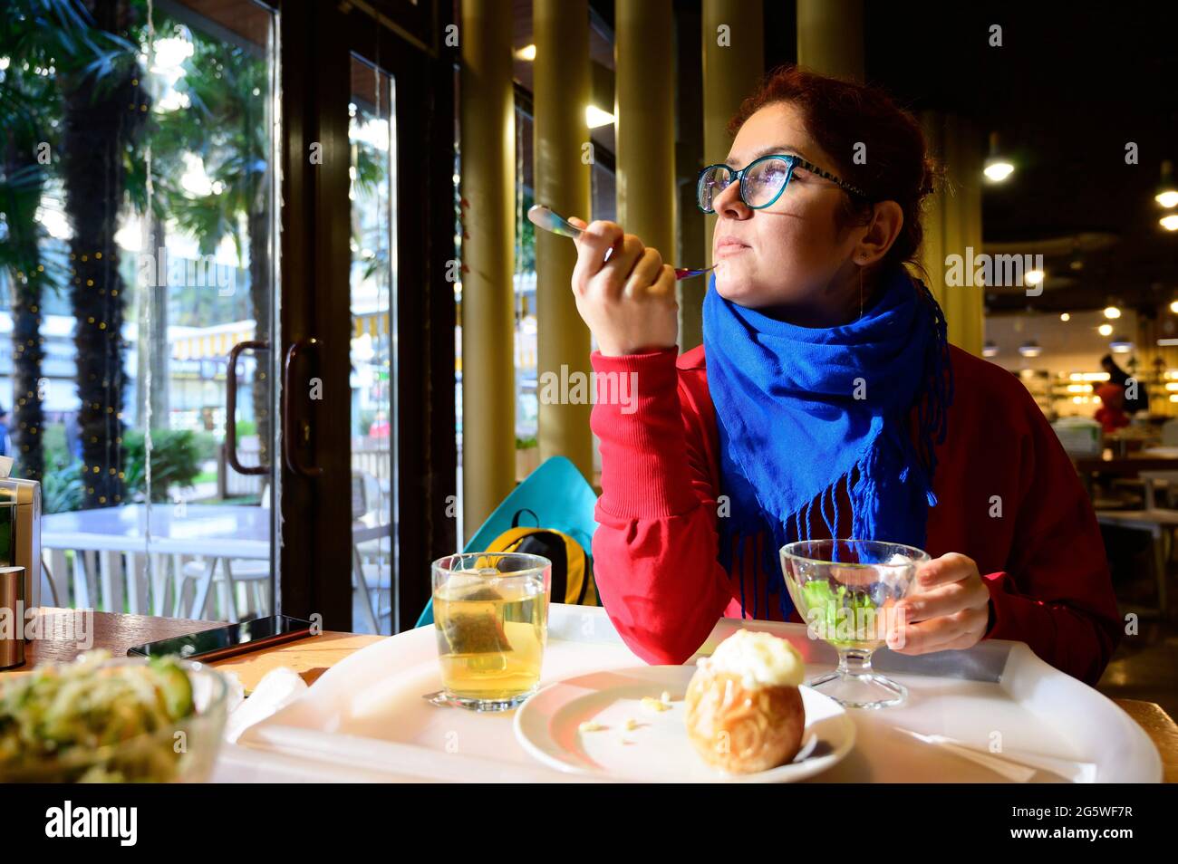 Attractive woman eating alone restaurant hi-res stock photography and ...