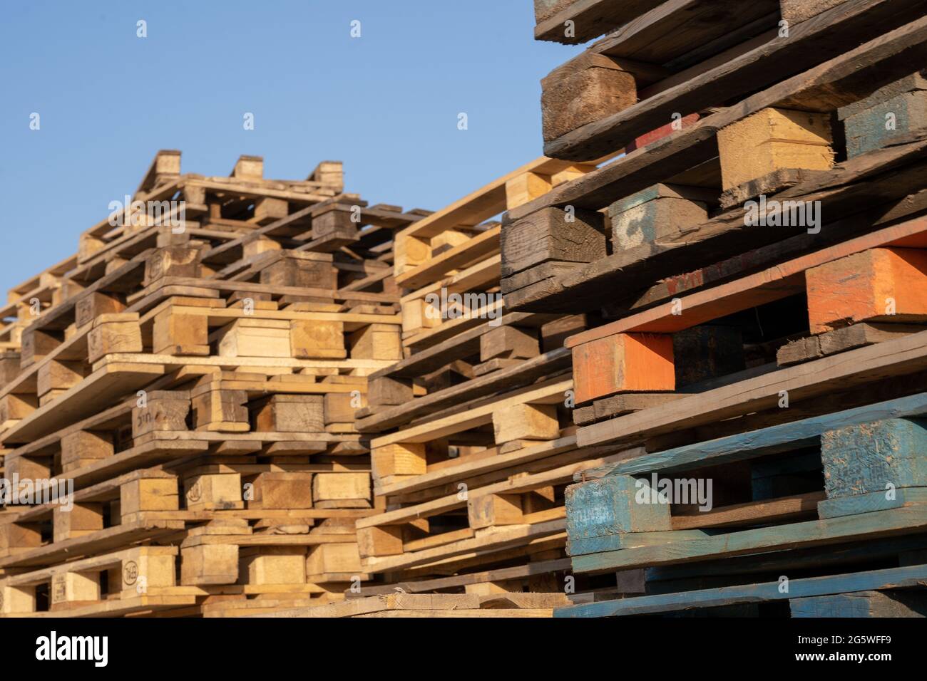 Used wooden pallets in stack in the warehouse. Wooden pallet overlap ...