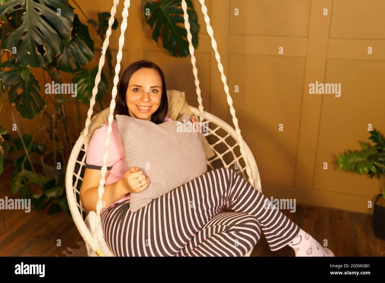 Cheerful youthful female enjoying healthy lifestyle while holding bell ...