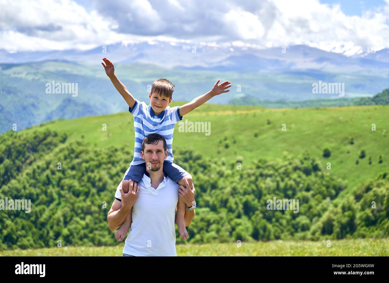 a child rides on his father's back Stock Photo - Alamy