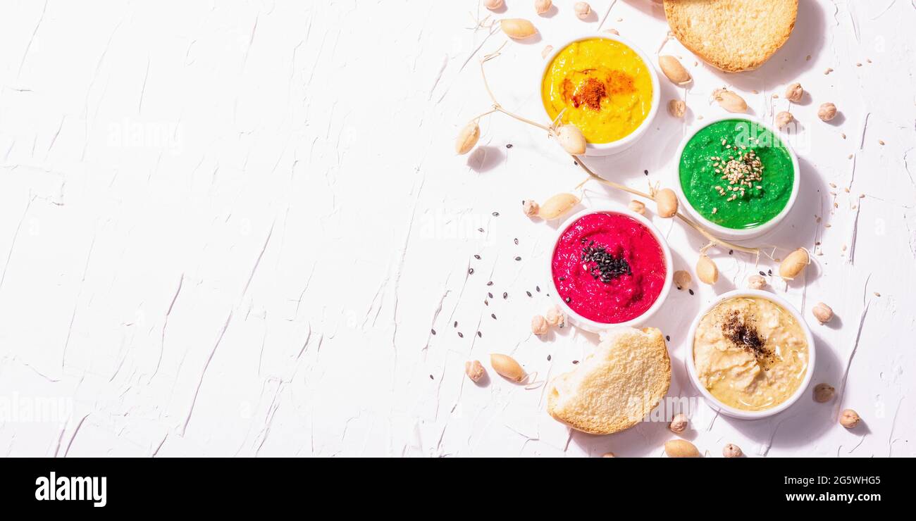 Various hummus dips, the flat lay of hummus in different colors with ...