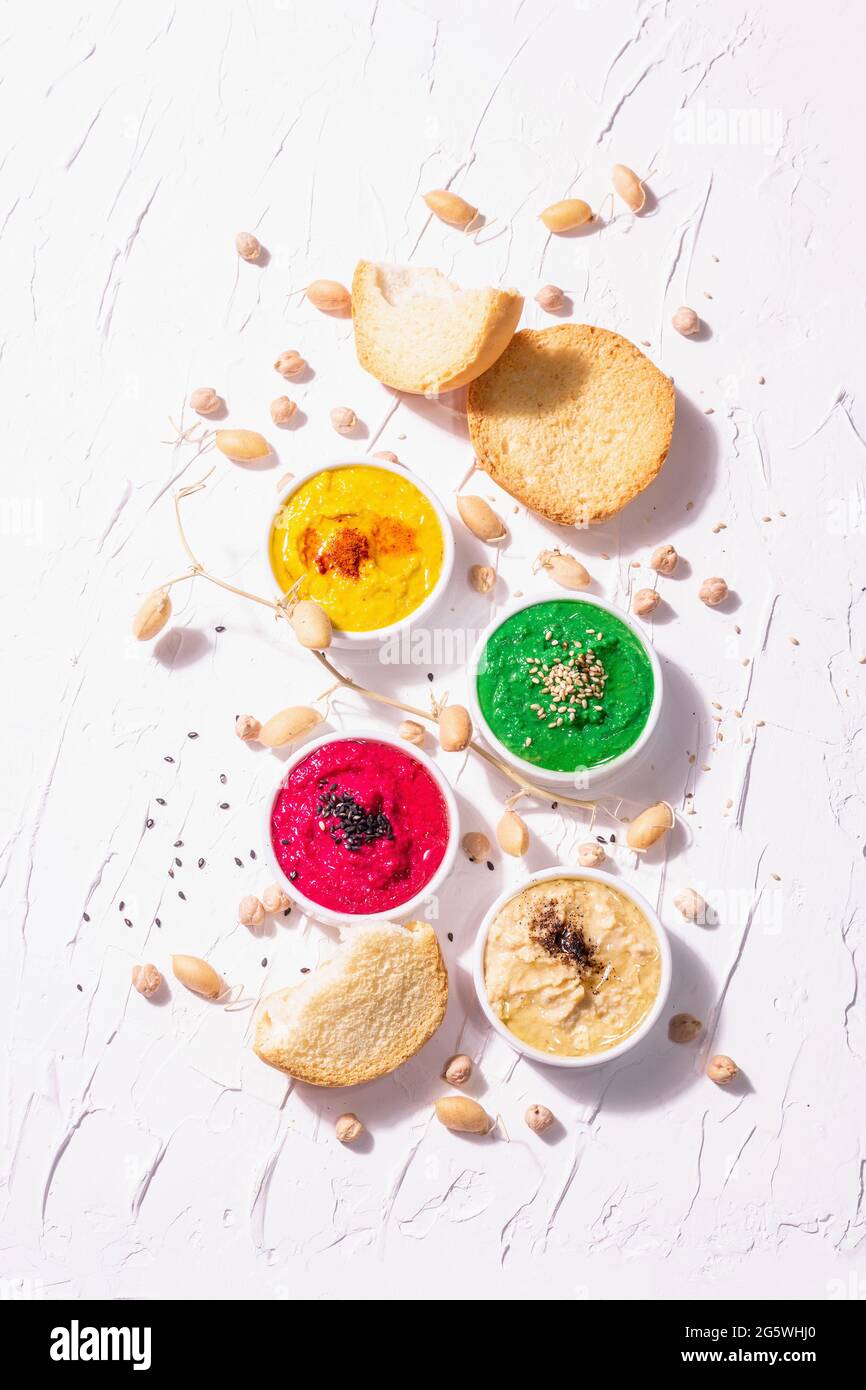 Various hummus dips, the flat lay of hummus in different colors with ...