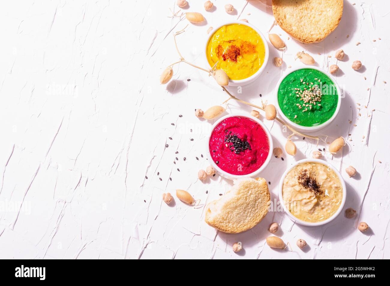 Various hummus dips, the flat lay of hummus in different colors with ...