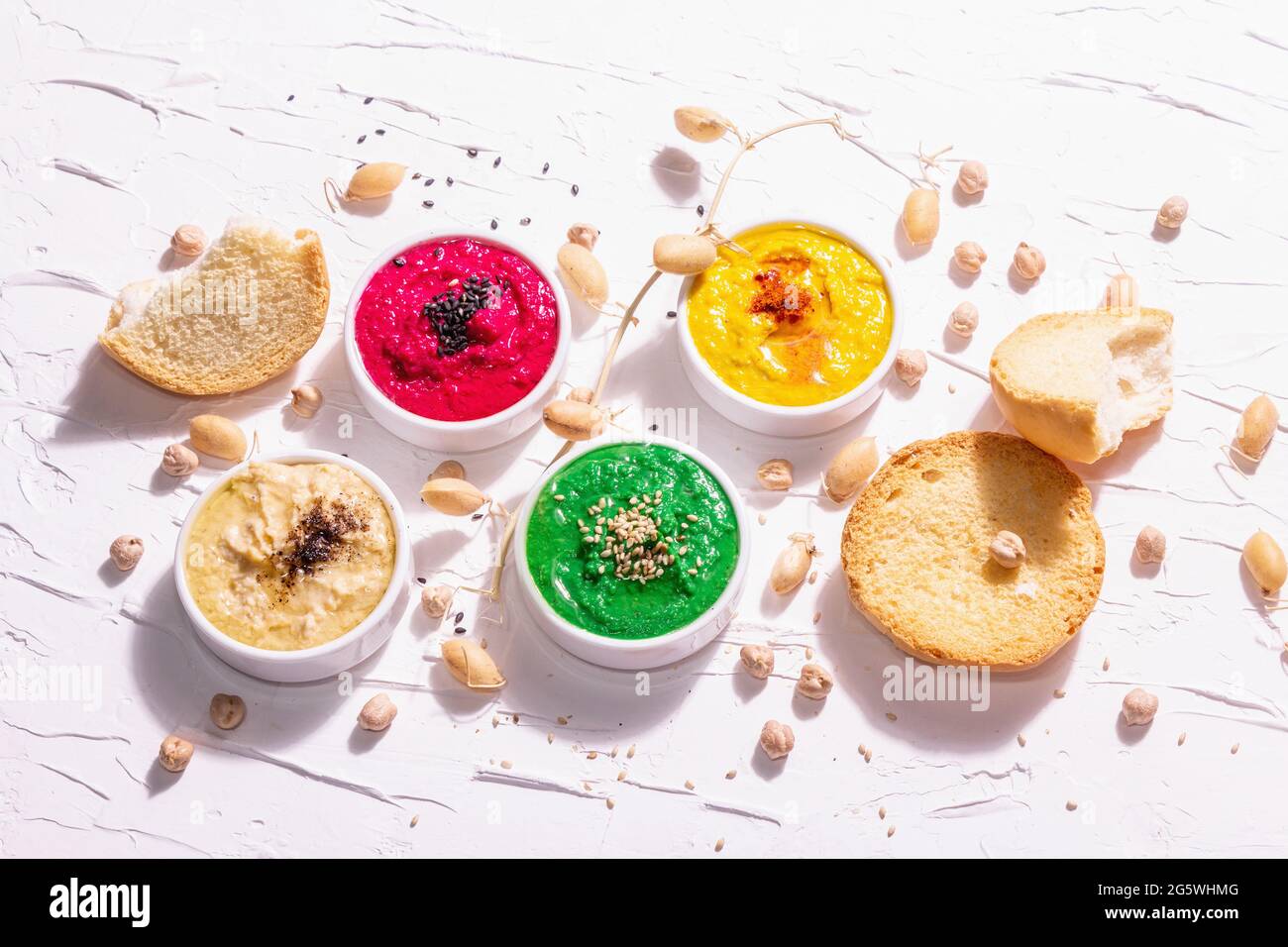 Various hummus dips, the flat lay of hummus in different colors with ...