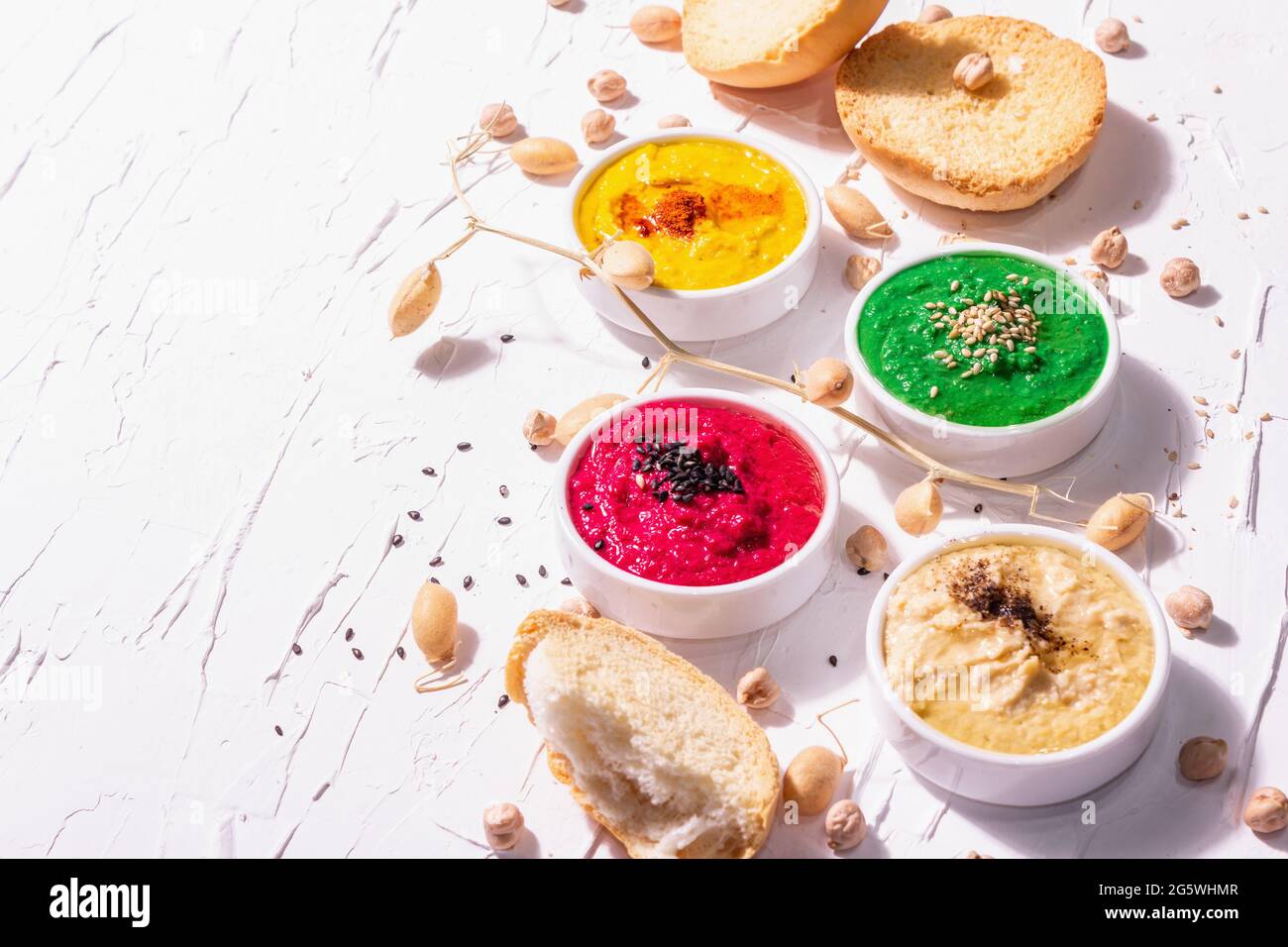 Various hummus dips, the flat lay of hummus in different colors with ...