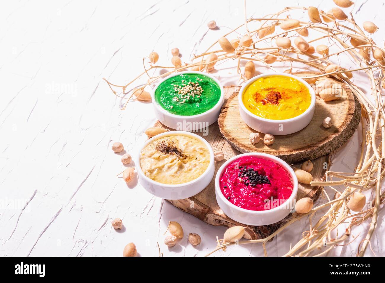 Various hummus dips, the flat lay of hummus in different colors with ...