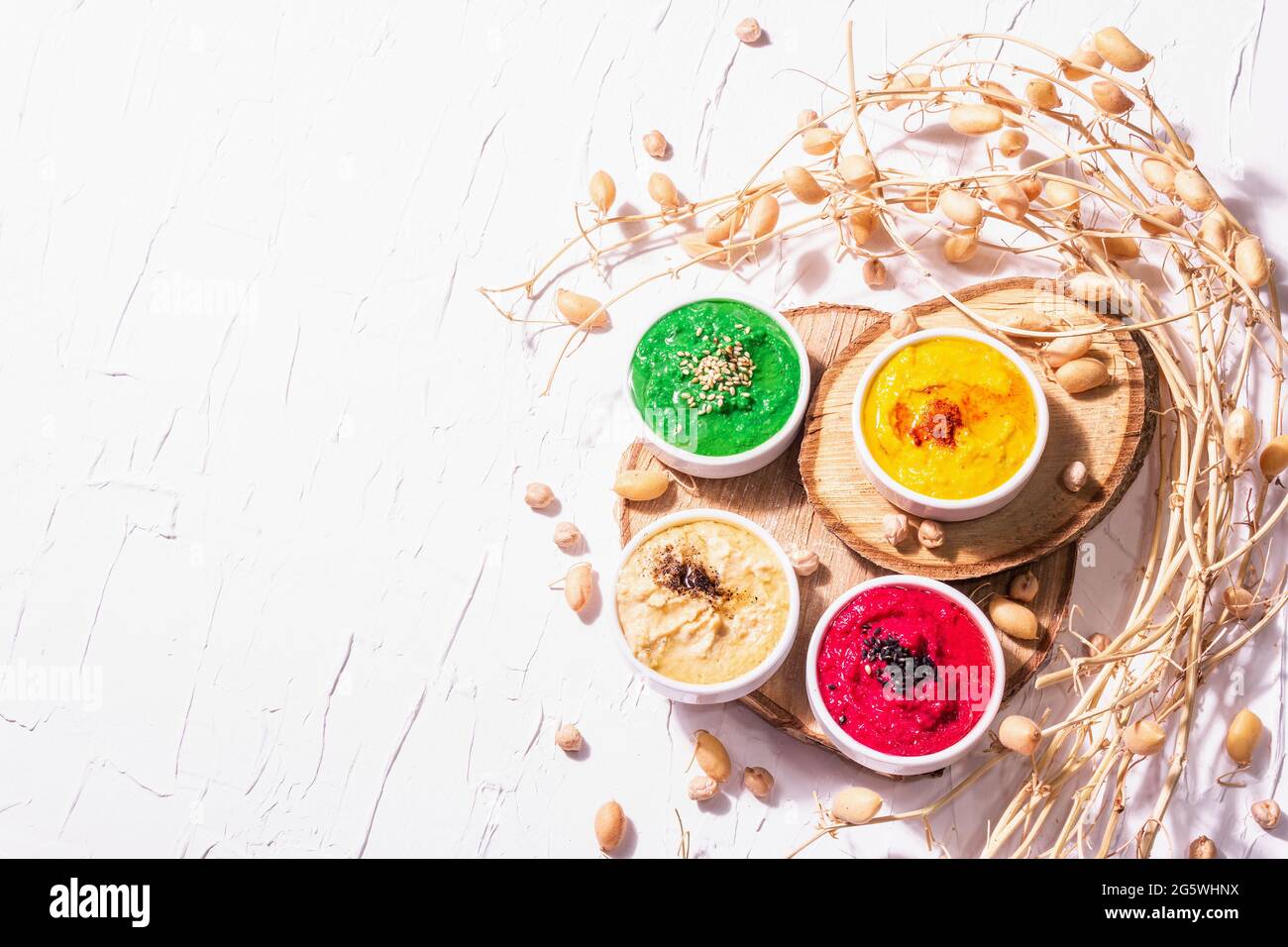 Various hummus dips, the flat lay of hummus in different colors with ...