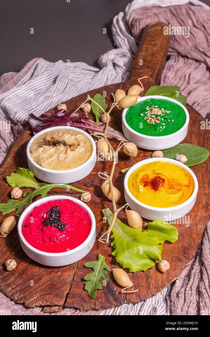 Colorful hummus bowls, healthy vegan dips. Traditional Middle Eastern ...