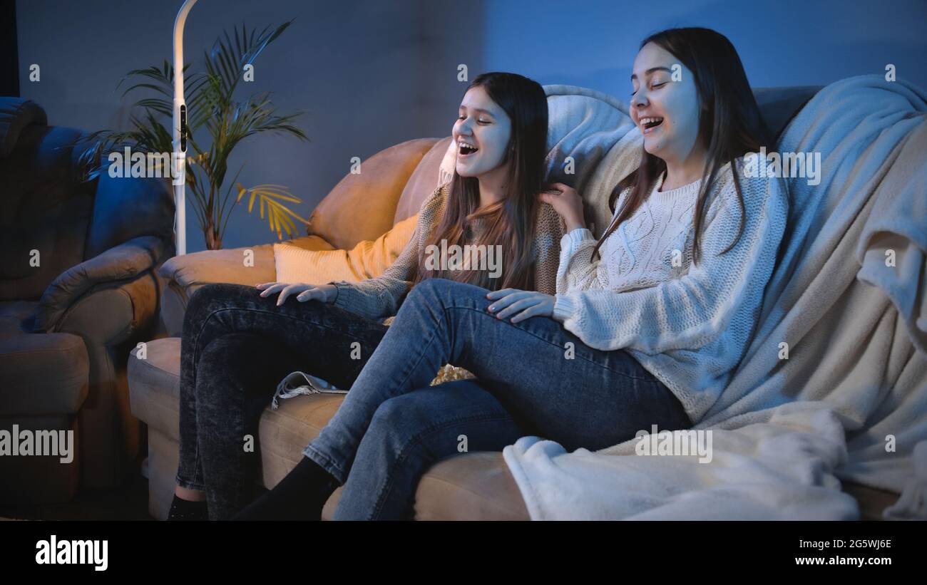 Two smiling girls laughing and smiling of funny comedy movie on ...