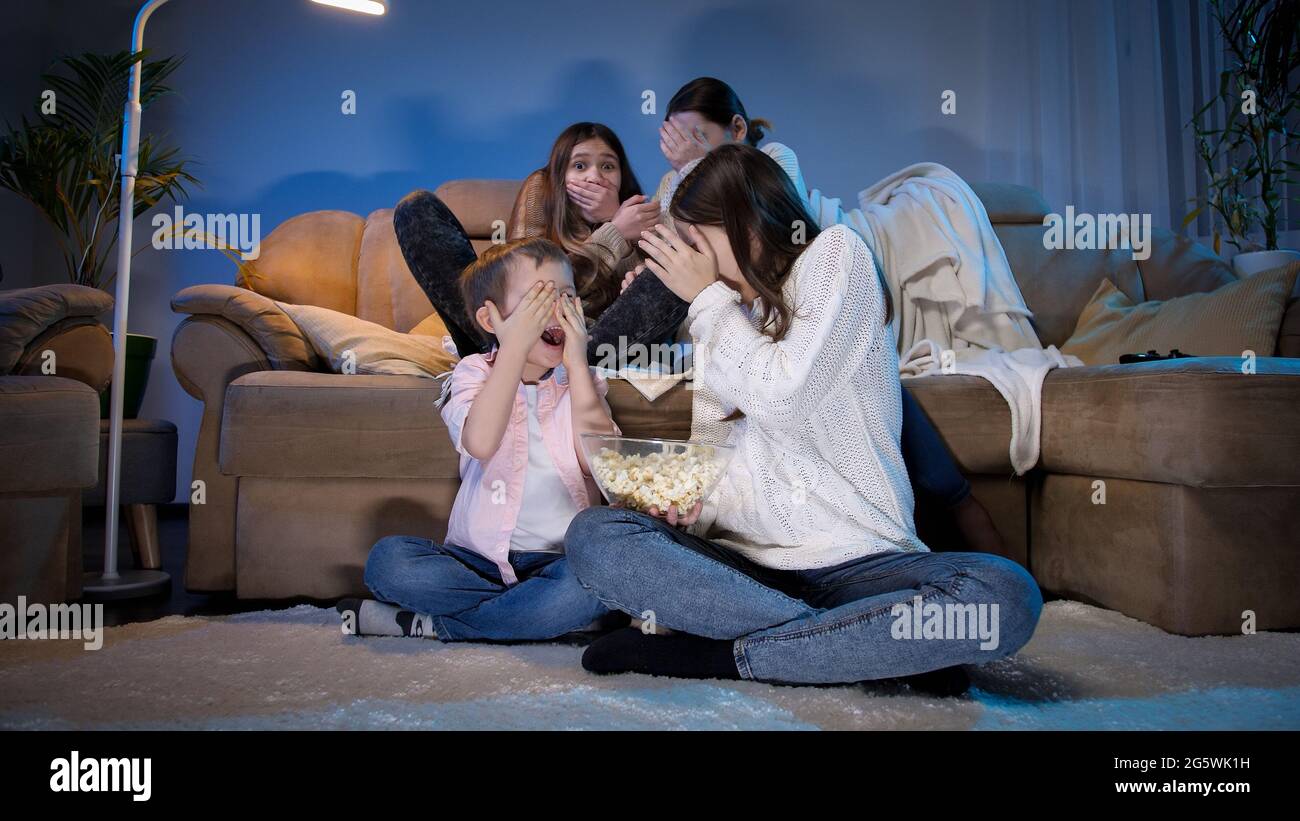 Big family got scared while watching scary horror movie or TV show at ...