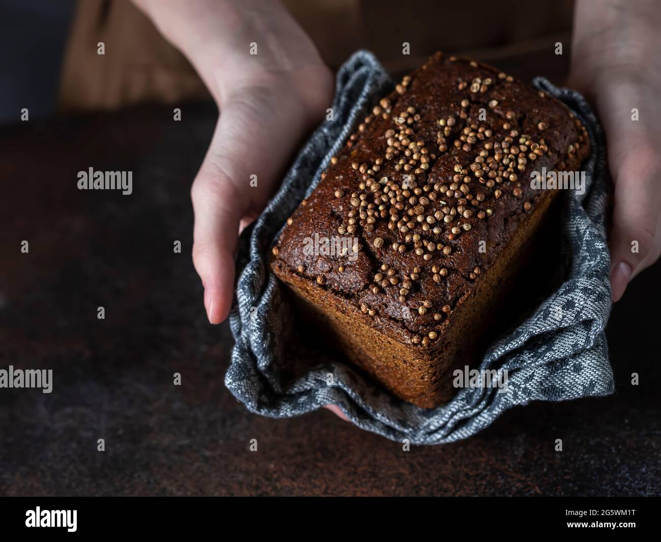 Traditional Russian rye Borodino bread. Female baker holds home made ...