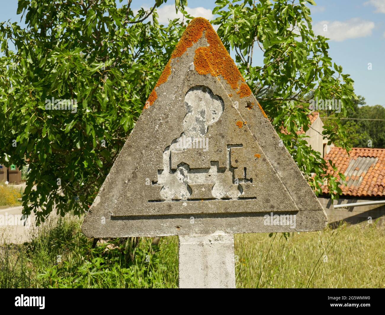 Concrete triangular train crossing sign rustic style in rural Portugal ...